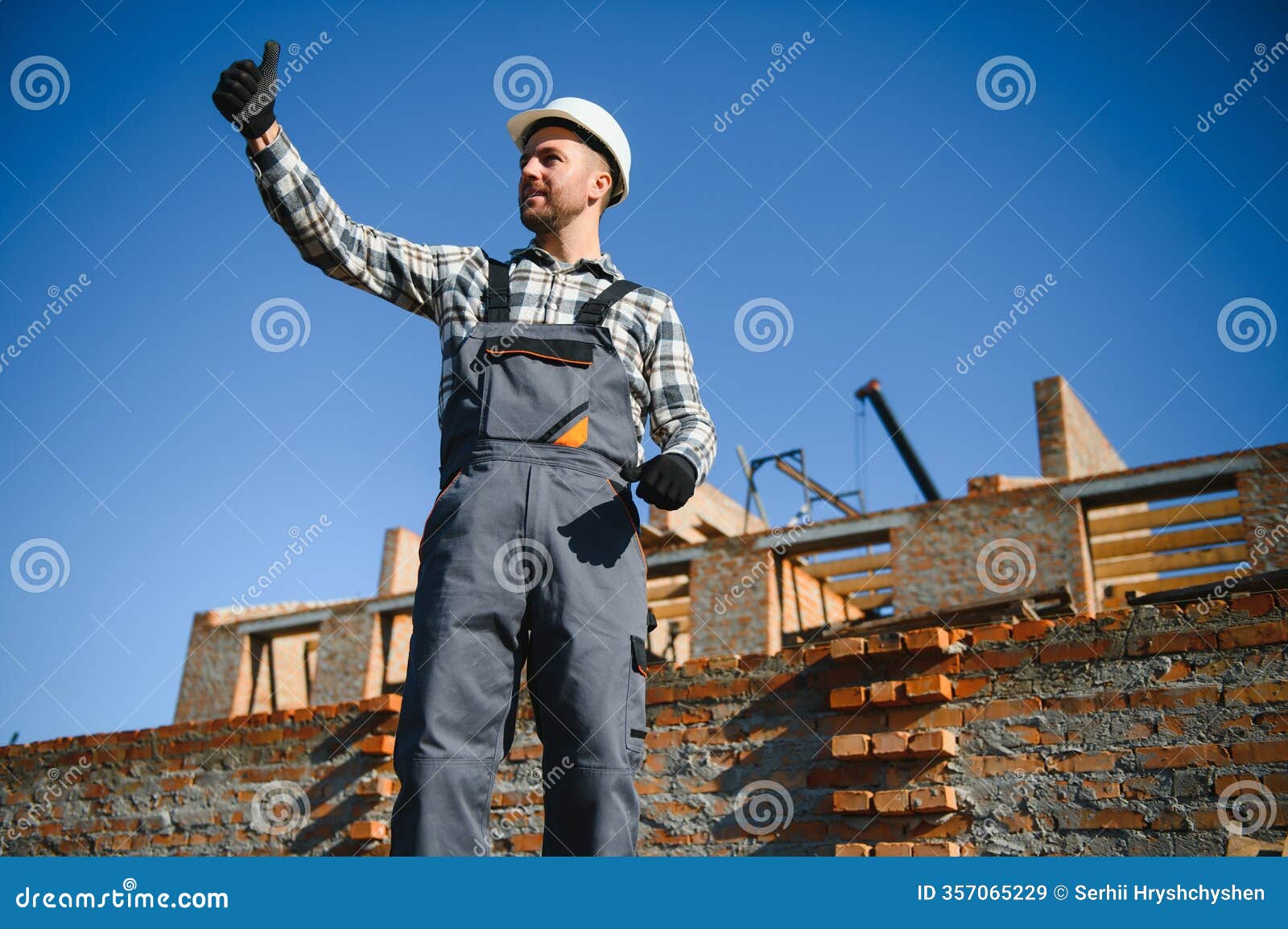 Installing Brick Wall. Construction Worker in Uniform and Safety ...
