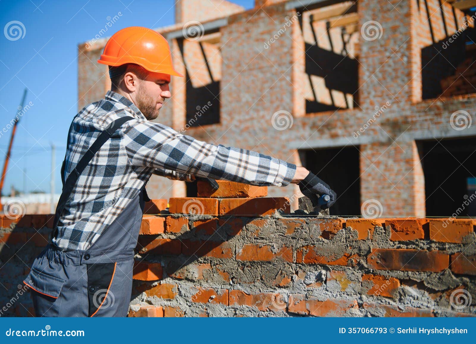 Installing Brick Wall. Construction Worker in Uniform and Safety ...