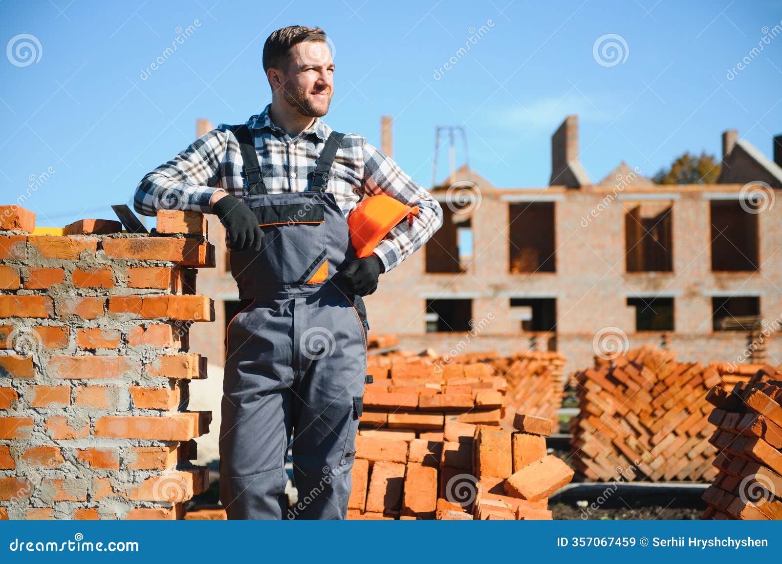 Installing Brick Wall. Construction Worker in Uniform and Safety ...