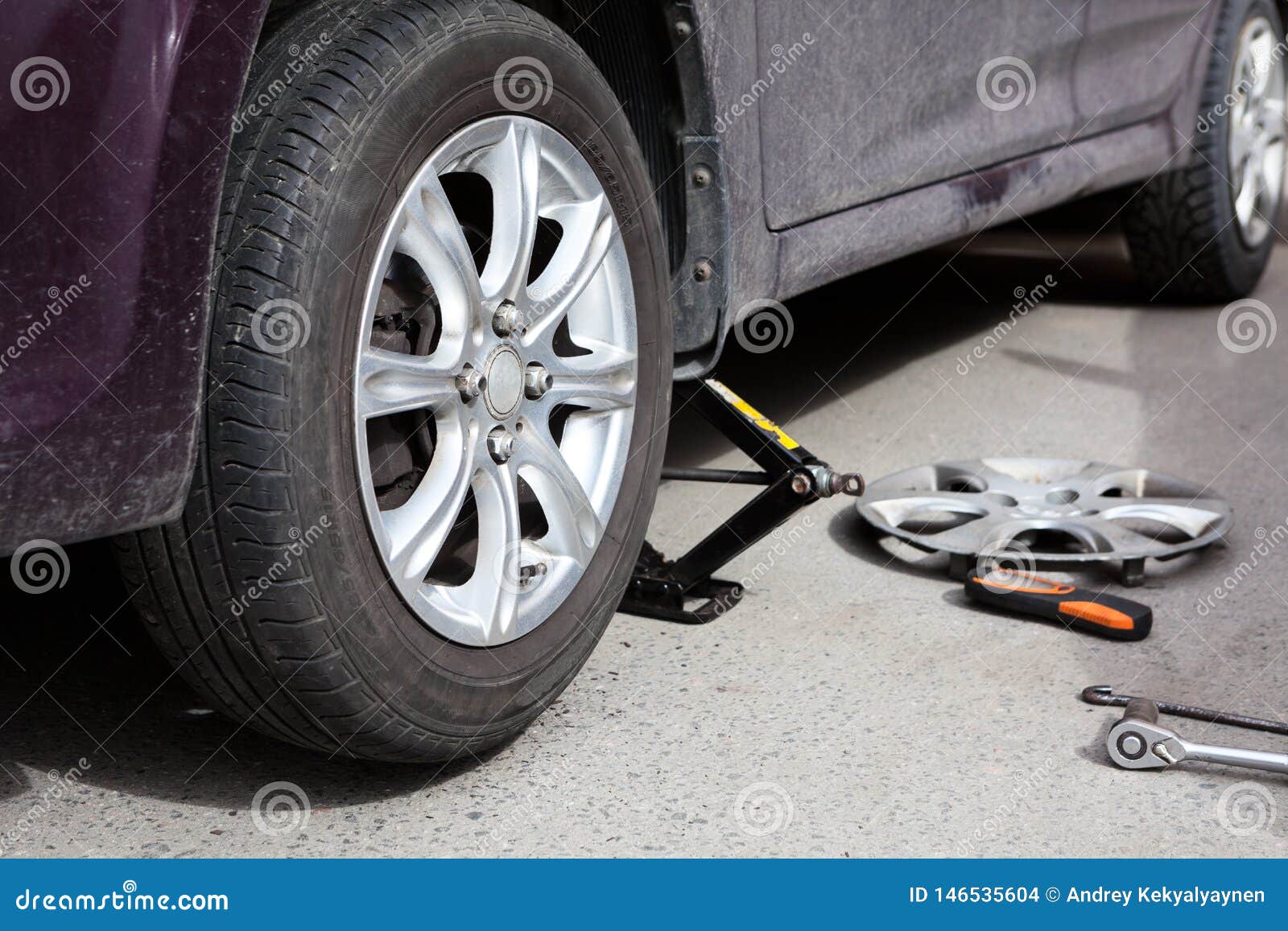 Installing Car Wheel with Levelling Hand Jack, Lifting Front Side of ...