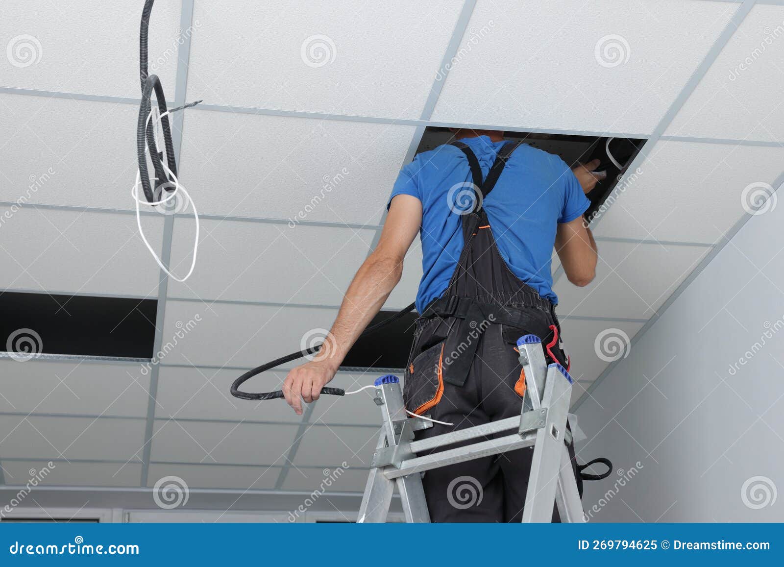 Installing Ceiling Lighting. Electrician Working on Step Ladder in Room ...