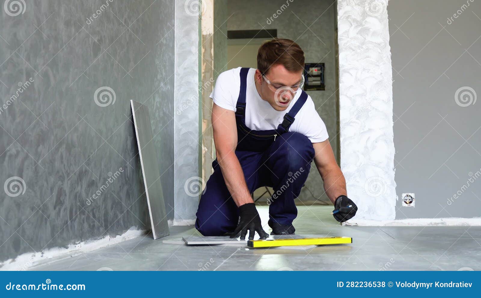 Installing Ceramic Floor Tiles Measuring and Cutting the Pieces Stock ...