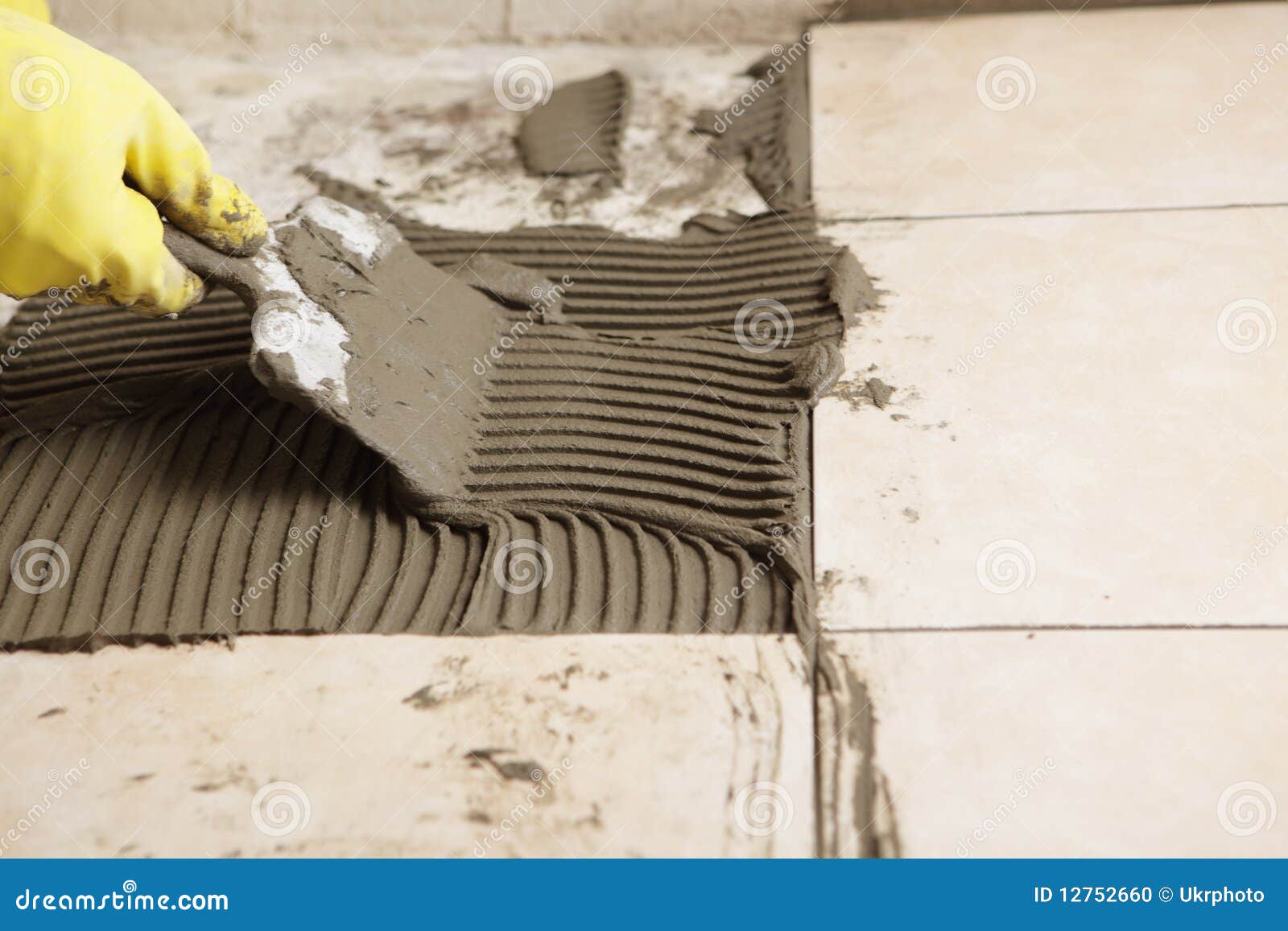 Installing Ceramic Flooring - Fitting A Tile Royalty-Free Stock Photo ...