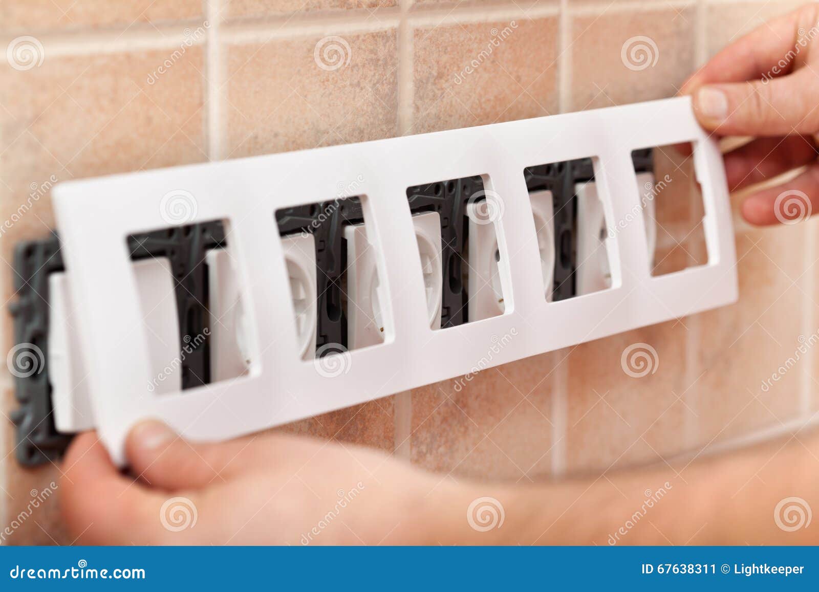 Installing Decorative Mask Onto Electrical Wall Fixture Stock Image ...