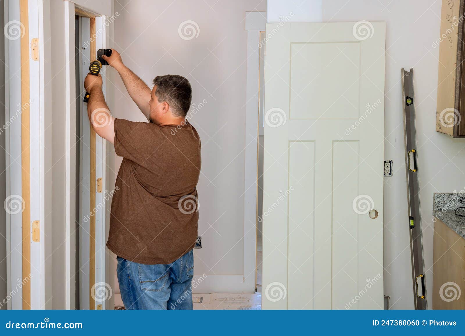 Installing the Door Hinge on the Door Frame Using a Screwdriver Stock ...