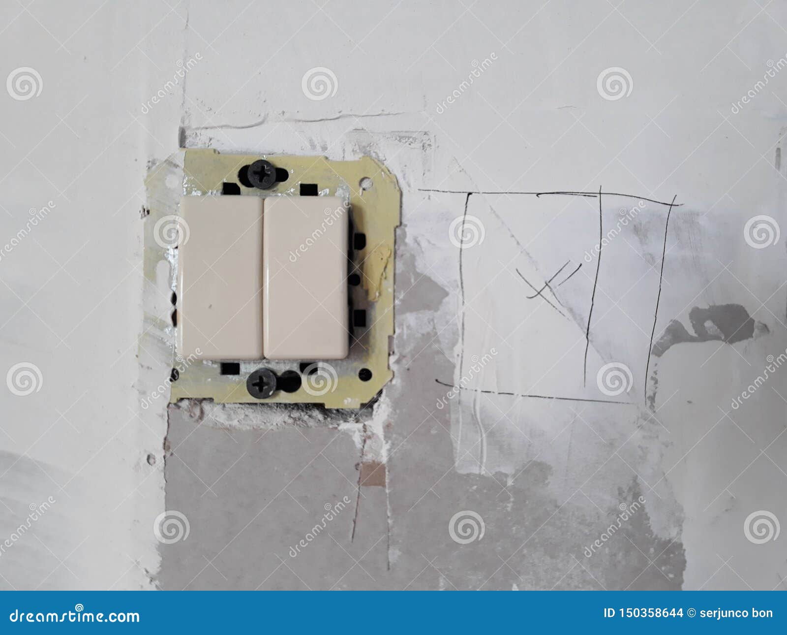 Installing an Electrical Switch in a House Under Renovation on the Wall ...