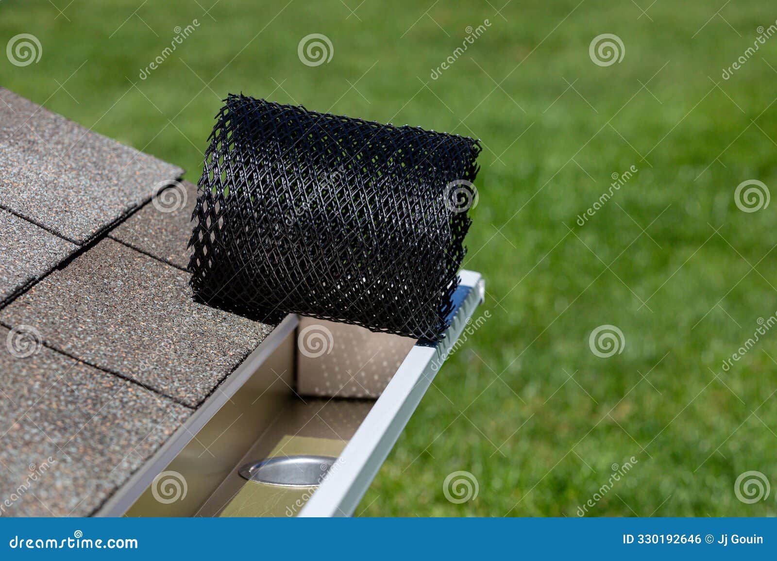 Installing Gutter Guard Mesh Screen on Rain Guttering. Stock Photo ...