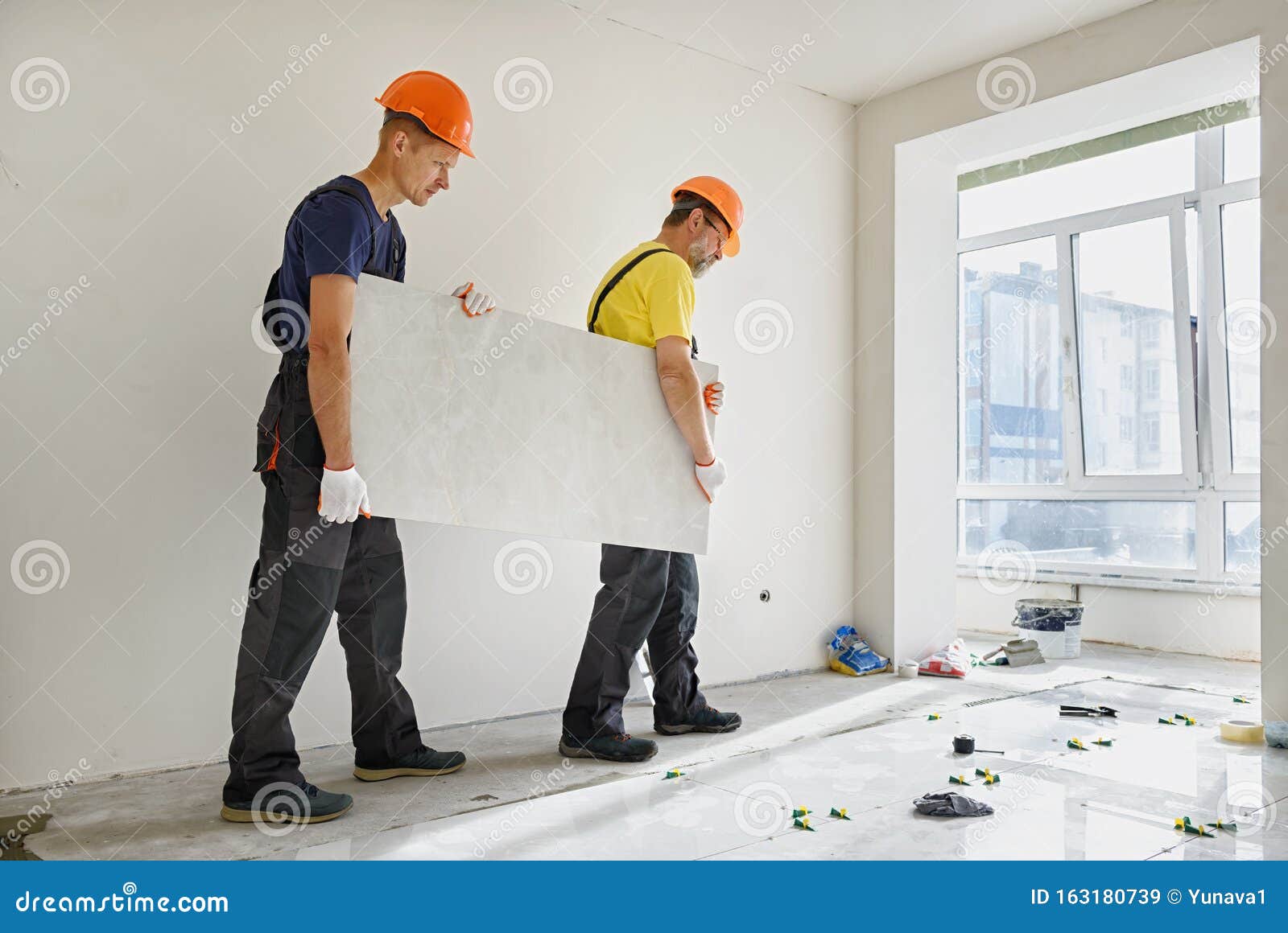 Installing a Large Ceramic Tile Stock Image - Image of installation ...