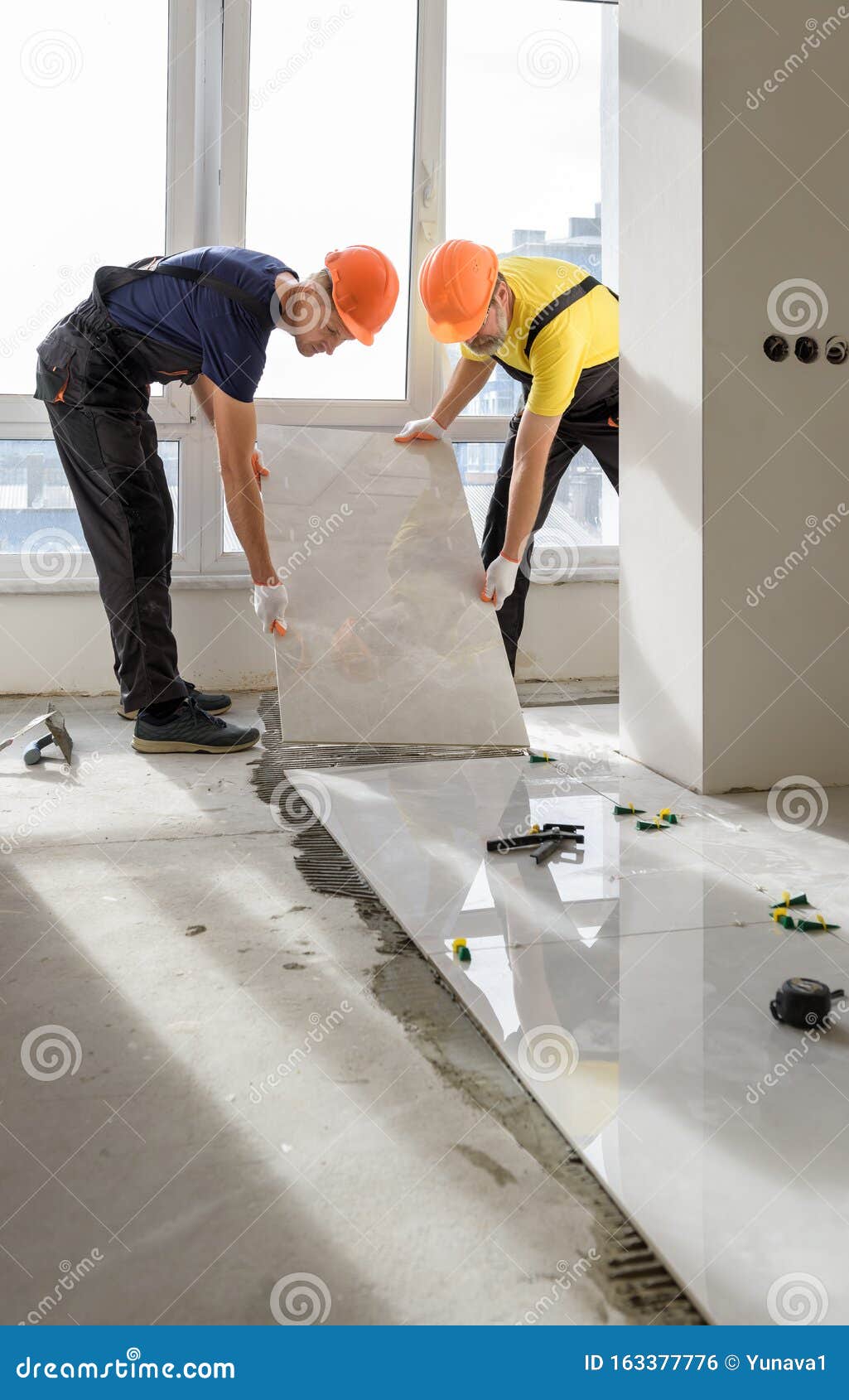 Installing A Large Ceramic Tile Stock Photography | CartoonDealer.com ...