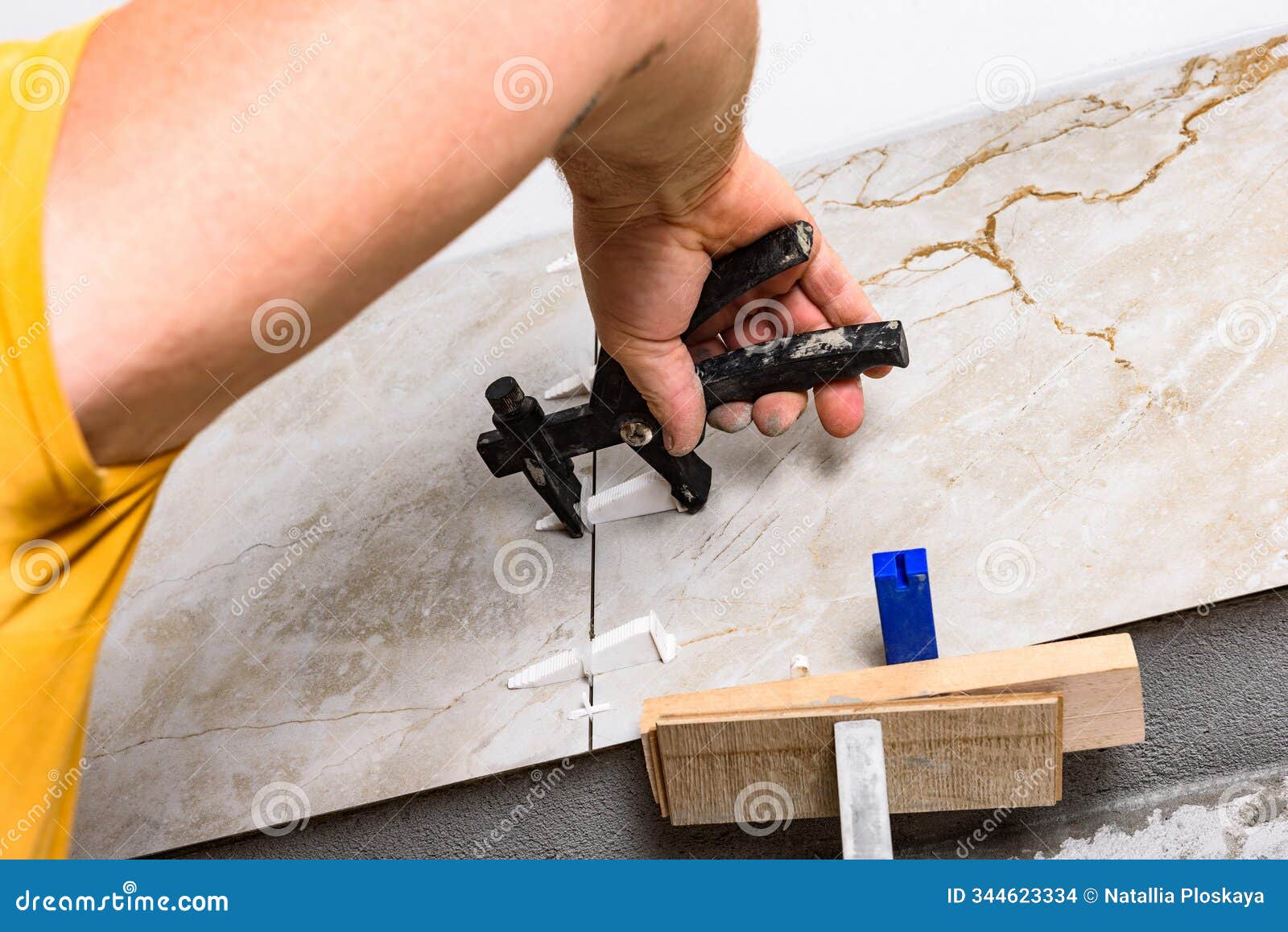 Installing Leveling System Tiles Using Black Tongs. Stock Photo - Image ...