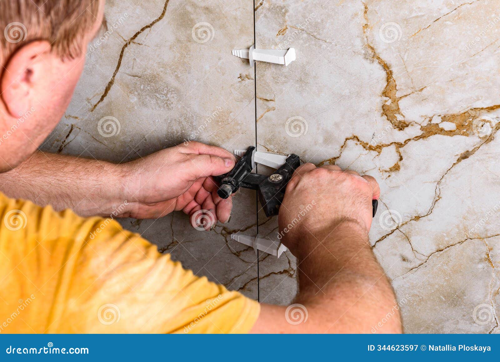Installing Leveling System Tiles Using Black Tongs. Stock Image - Image ...
