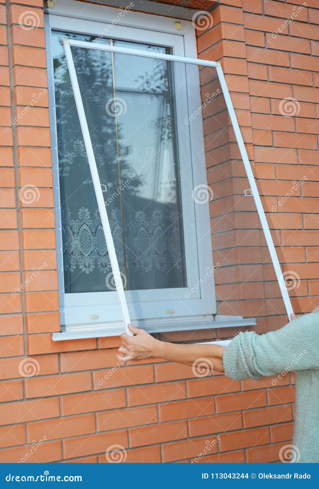 Installing Mosquito Net, Mosquito Wire Screen on Brick House Wi Stock ...