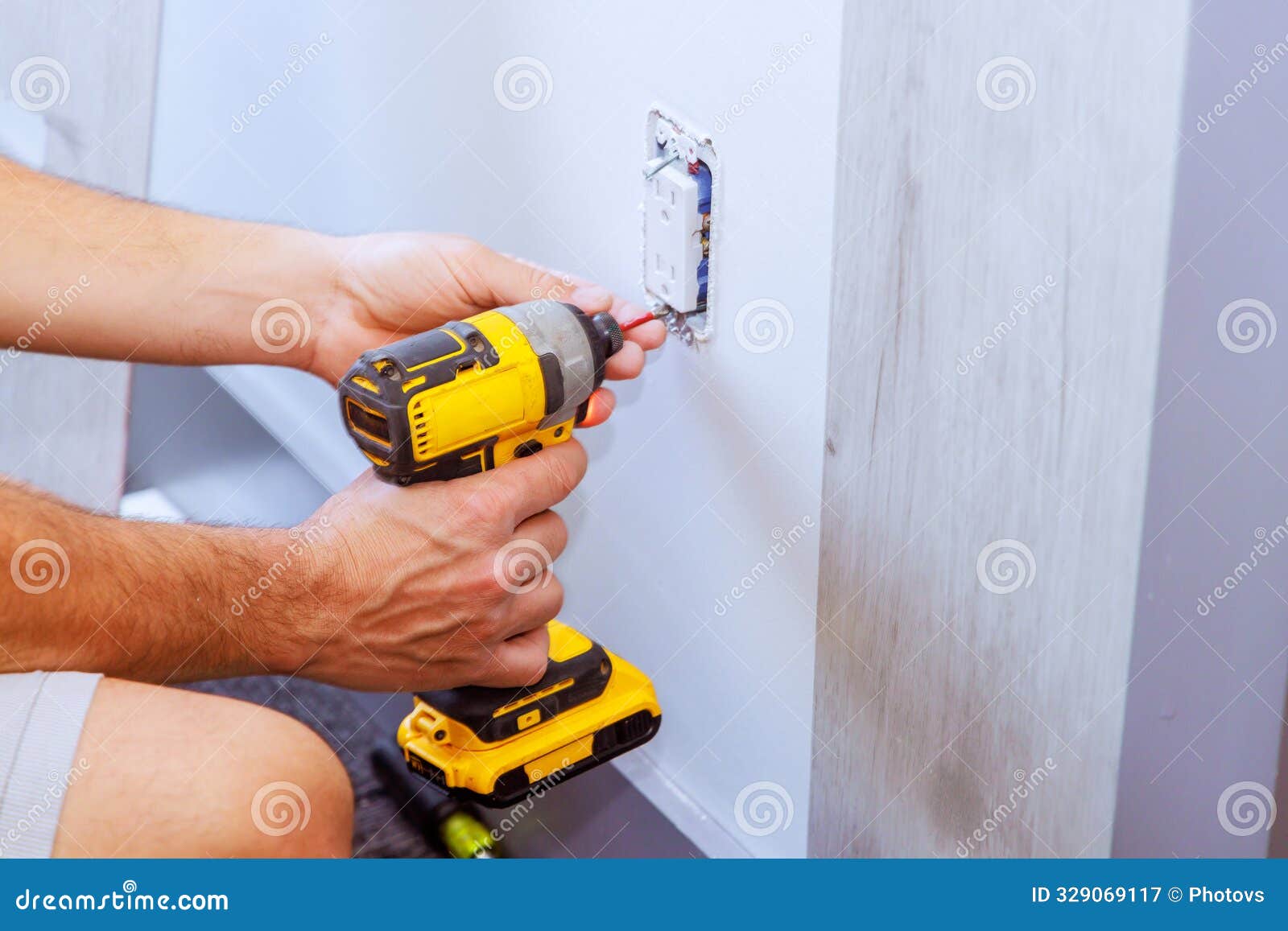 Installing an Outlet with Screwdriver in a House during Reconstruction ...