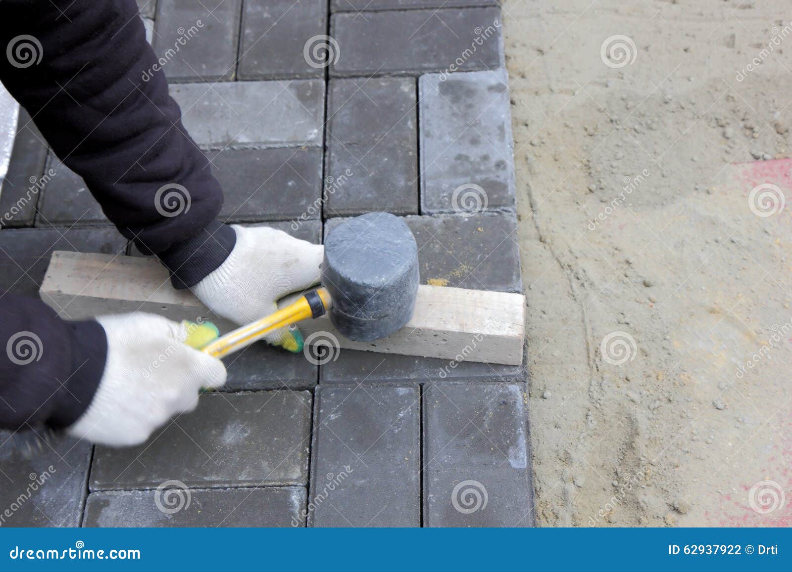 Installing Paving Slabs with a Mallet Stock Photo - Image of brick ...