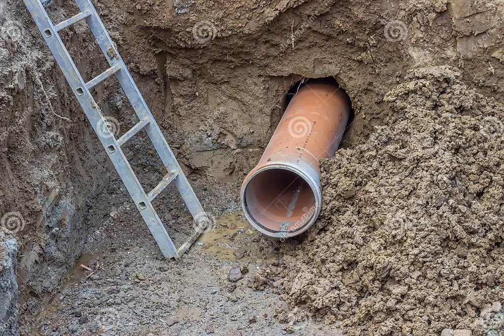 Installing Pipes Under the Road Stock Photo - Image of orange ...