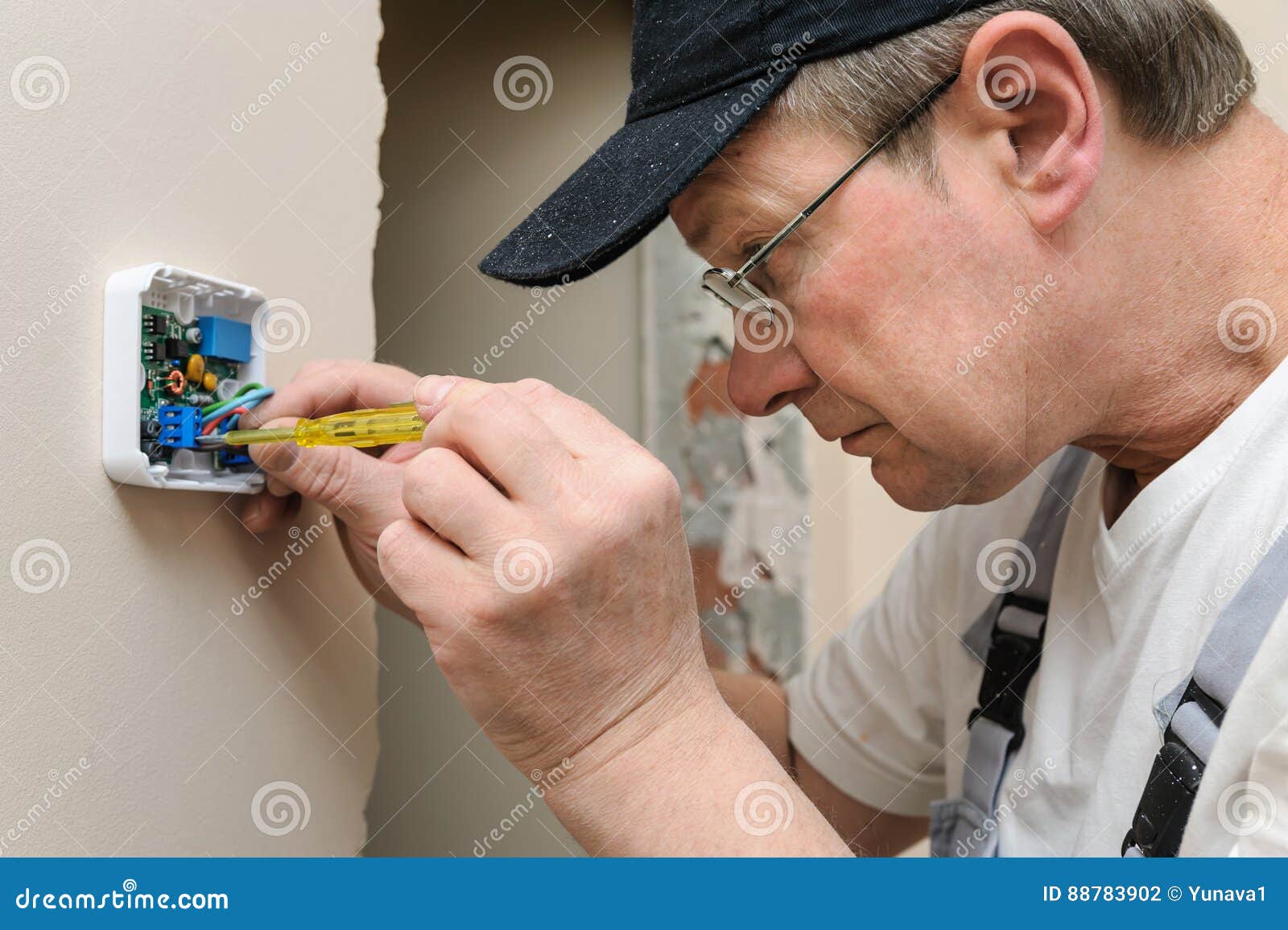 Installing A Programmable Room Thermostat. Stock Photo | CartoonDealer ... Installing A Programmable Room Thermostat. Stock Photo | CartoonDealer ...