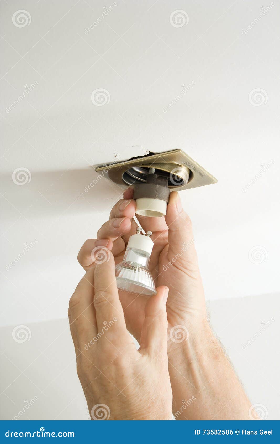 Installing or Replacing a Halogen Spot Light Lamp Stock Photo - Image ...
