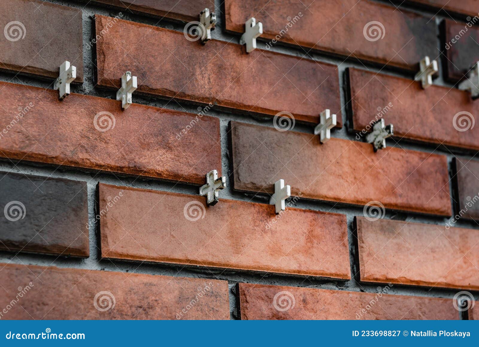 Installing The Tiles In The Form Of Brick On The Wall Using Plastic ...