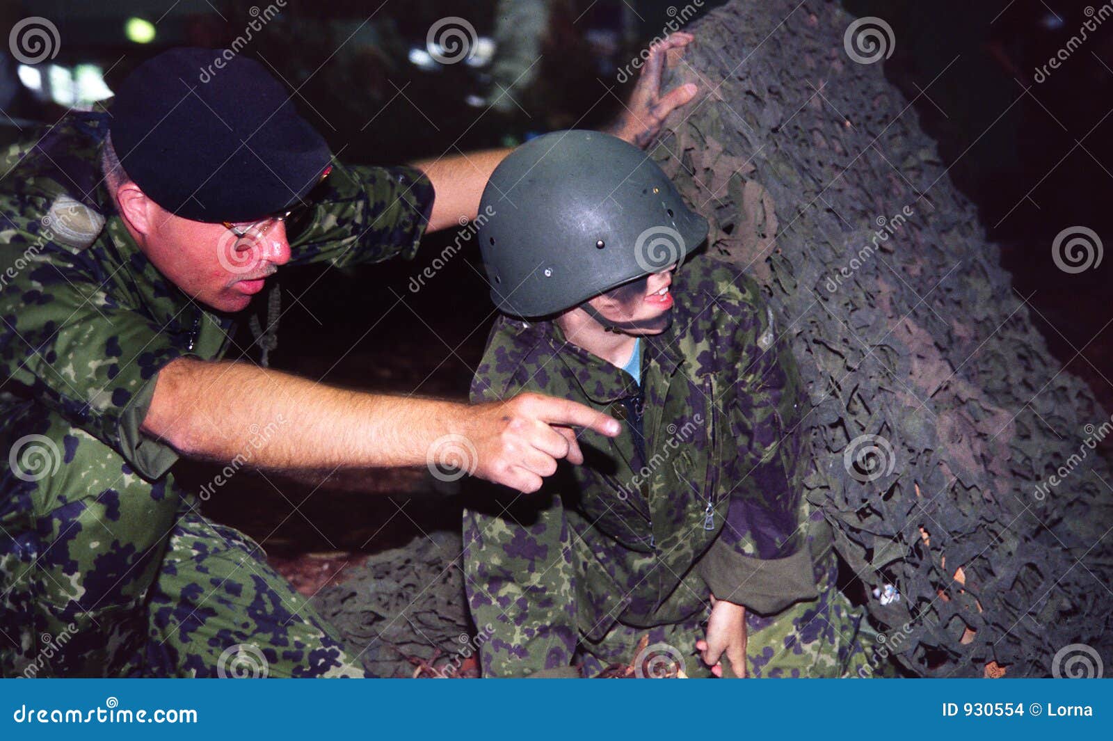 Instructing child soldier stock photo. Image of disguise - 930554