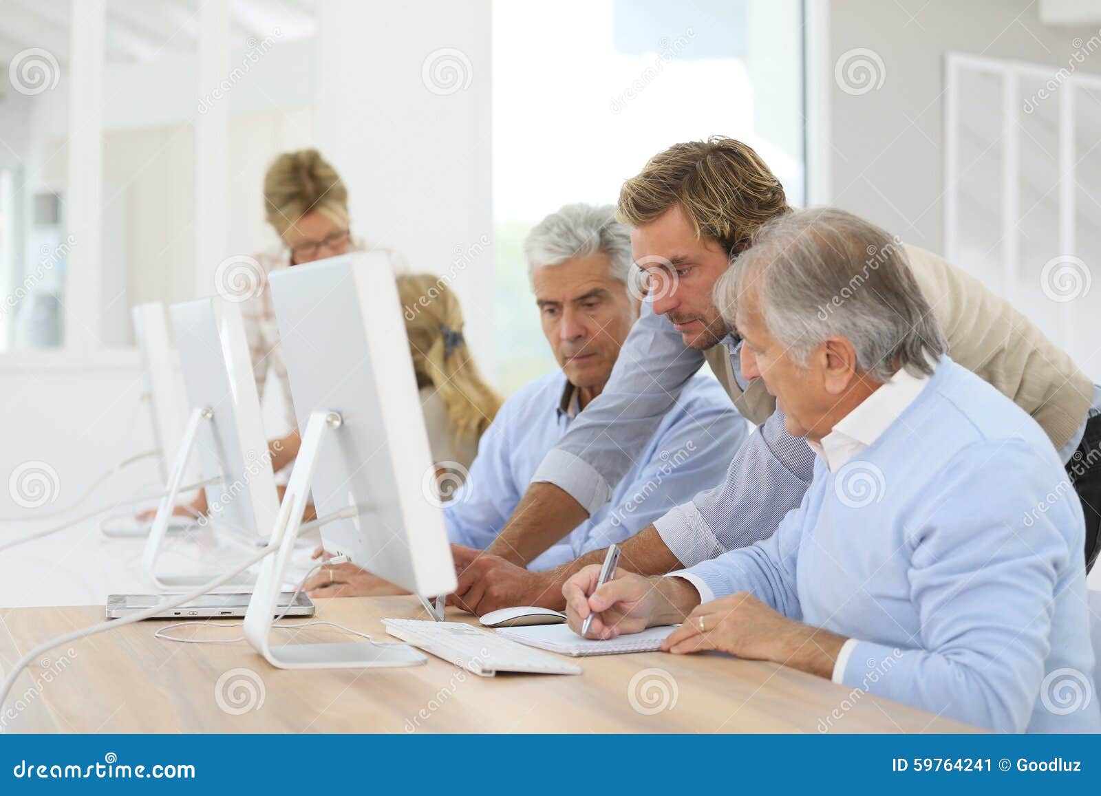 Instructor Assisting Seniors in Class Stock Image - Image of consulting ...