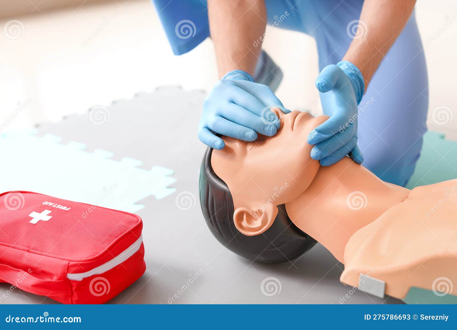 Instructor Demonstrating CPR on Mannequin at First Aid Training Course ...
