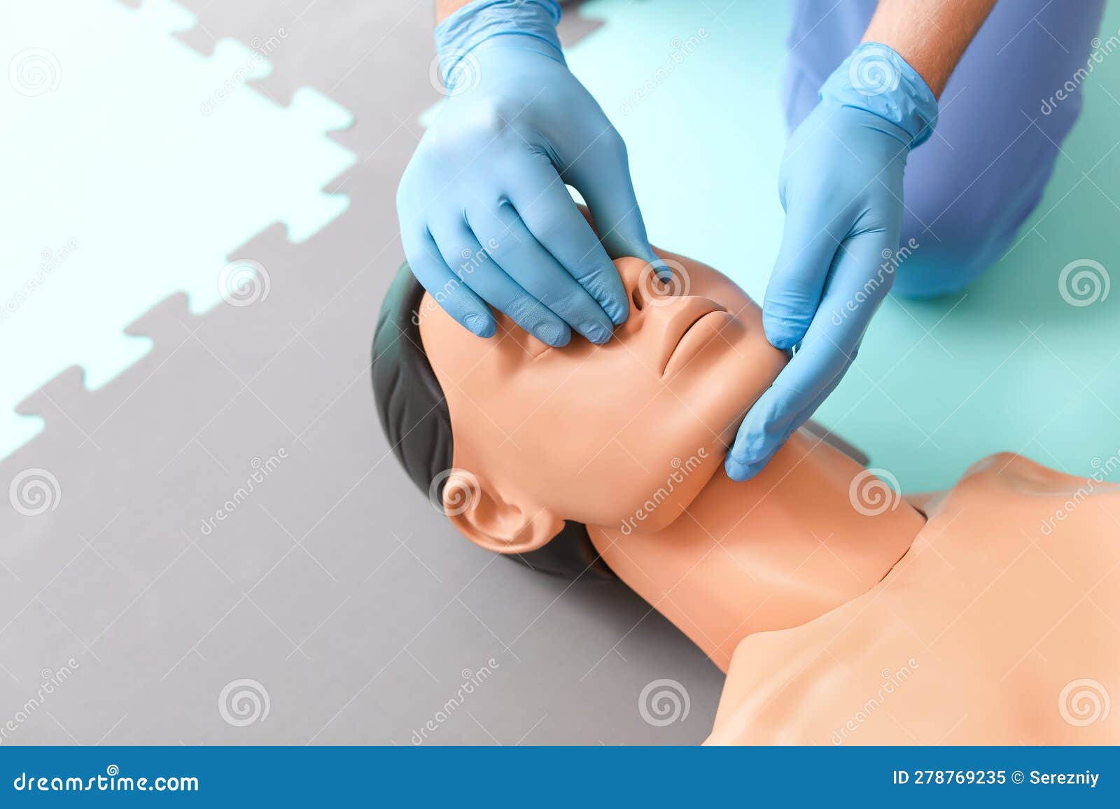 Instructor Demonstrating CPR on Mannequin at First Aid Training Course ...