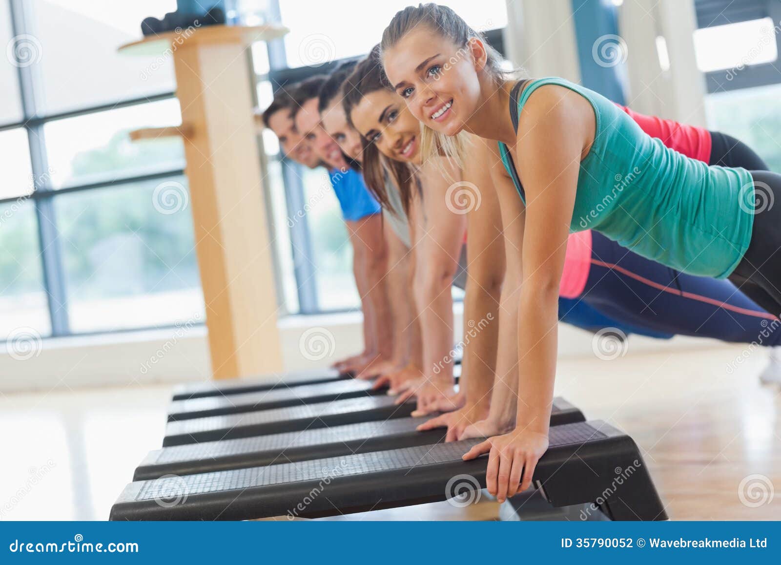 Instructor with Fitness Class Performing Step Aerobics Exercise Stock ...