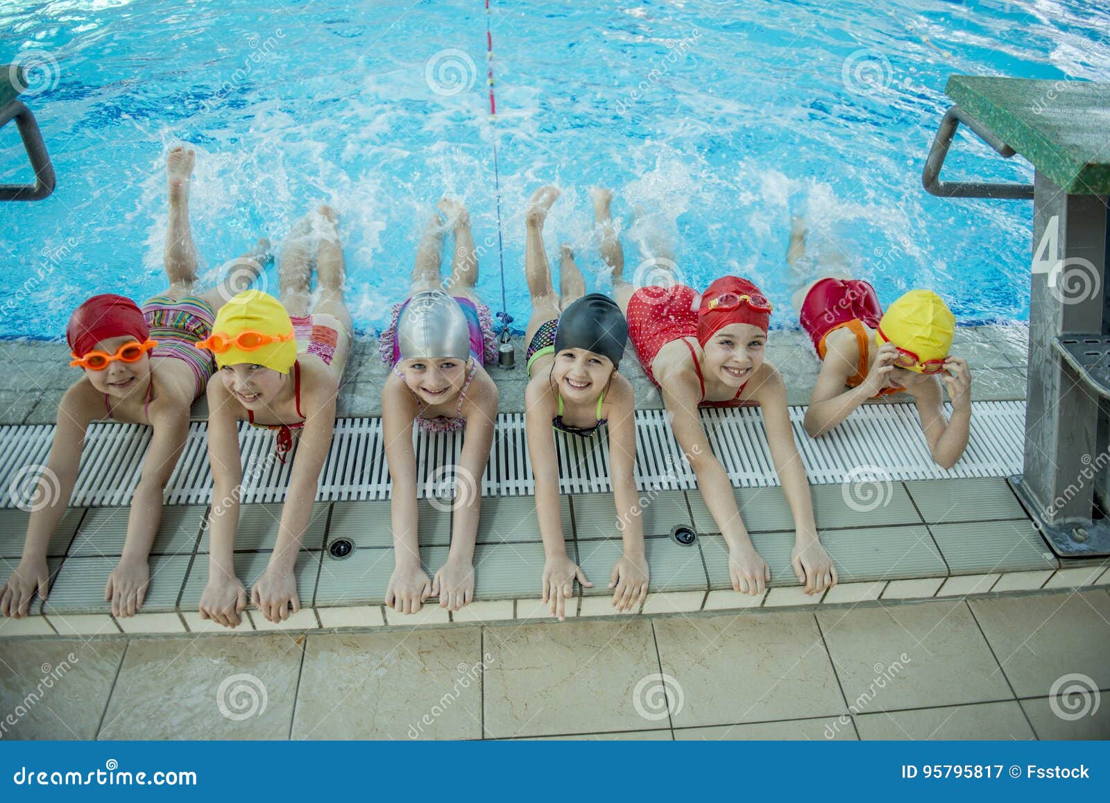 Instructor and Group of Children Doing Exercises Near a Swimming Pool ...