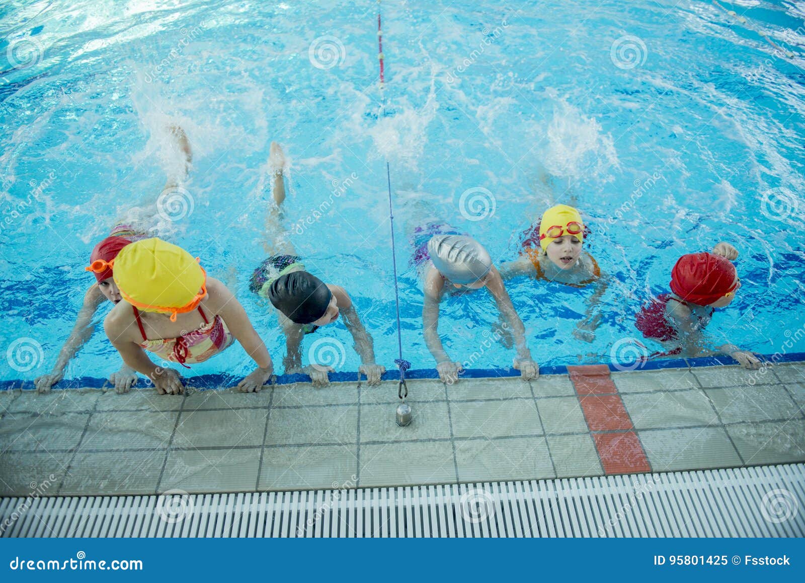Instructor and Group of Children Doing Exercises Near a Swimming Pool ...