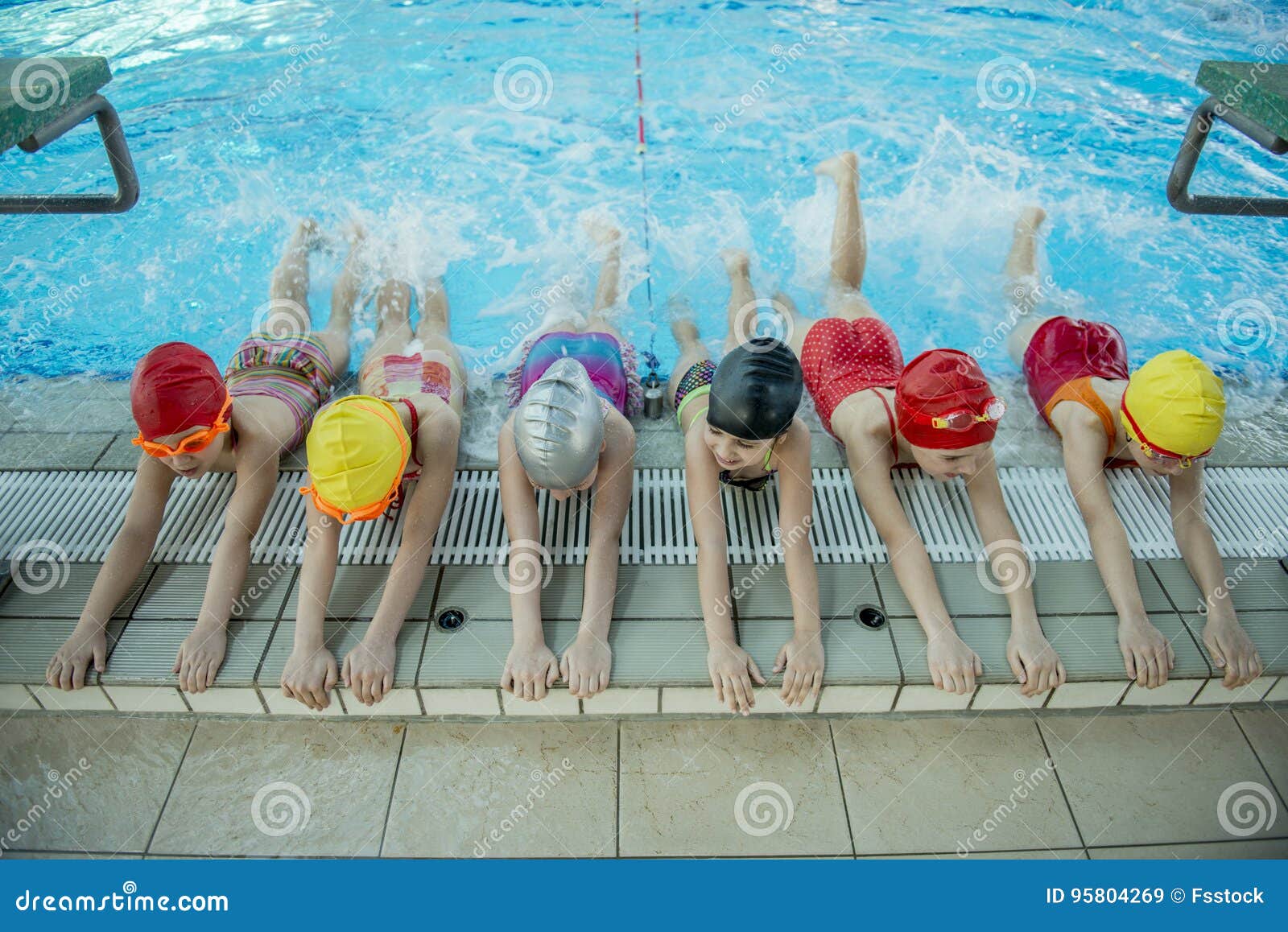 Instructor and Group of Children Doing Exercises Near a Swimming Pool ...