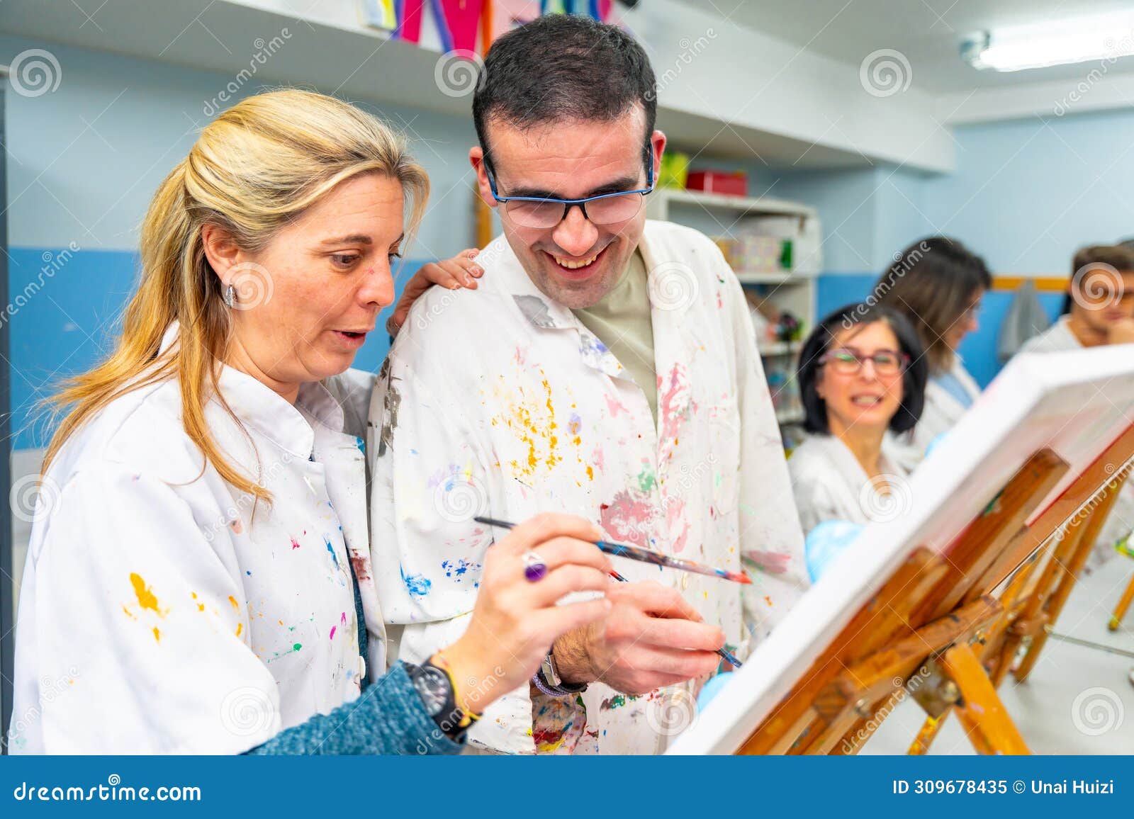 Instructor Helping a Disabled Man during Painting Class Stock Image ...