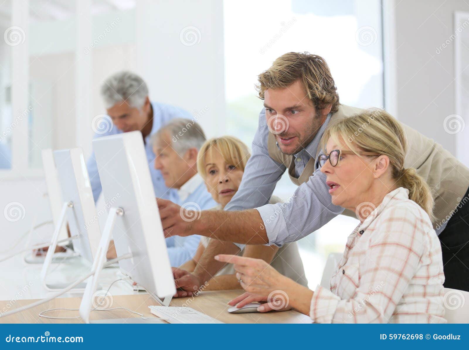Instructor Helping Seniors in Class Stock Photo - Image of conversion ...