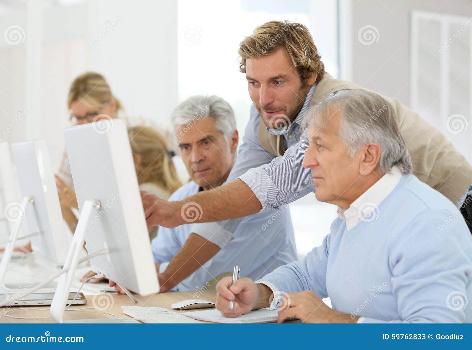 Instructor Helping Seniors in Informatics Class Stock Image - Image of ...