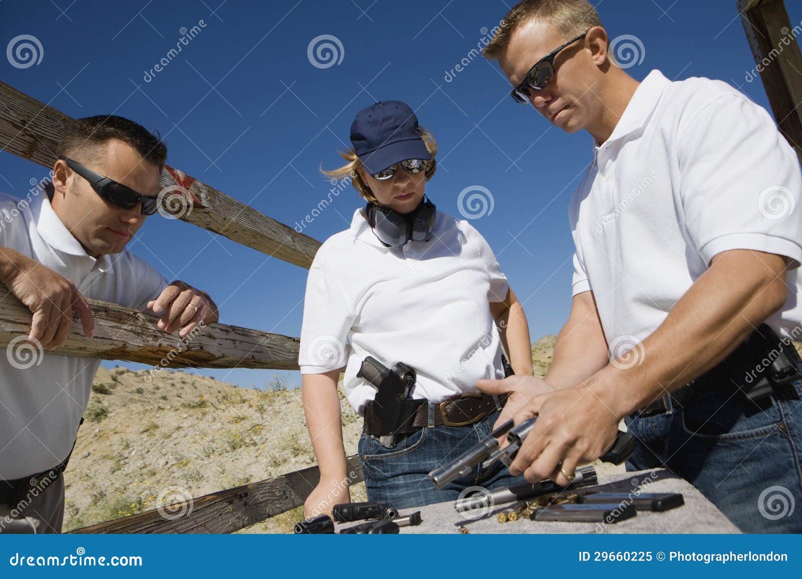 Instructor Loading Gun for Man and Woman Stock Image - Image of helping ...