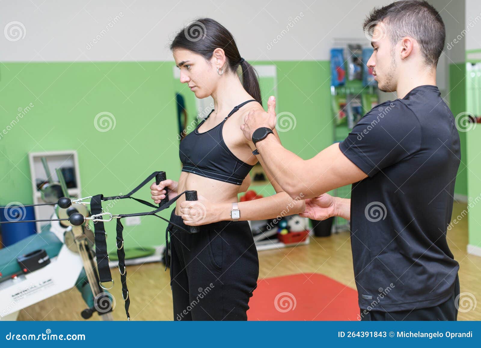 Instructor Makes a Girl Perform Back and Shoulder Exercise Stock Image ...