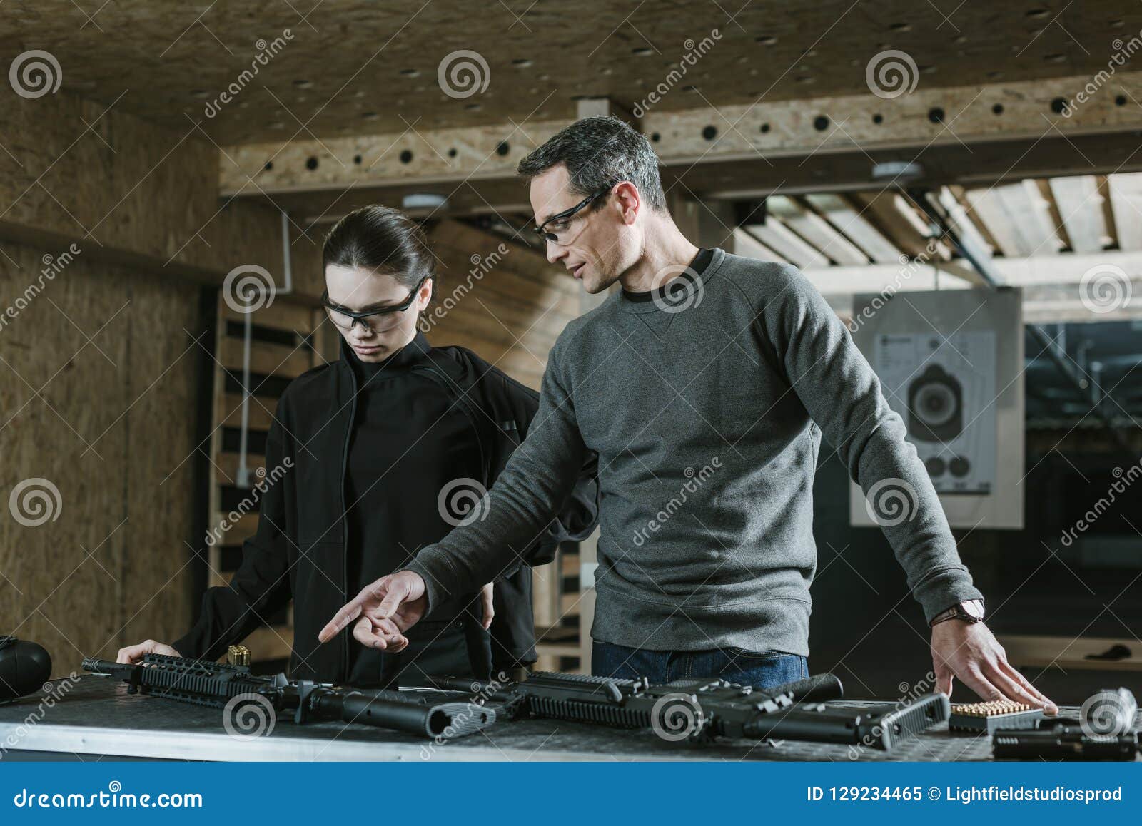 Instructor Pointing on Rifle on Table Stock Image - Image of pointingon ...