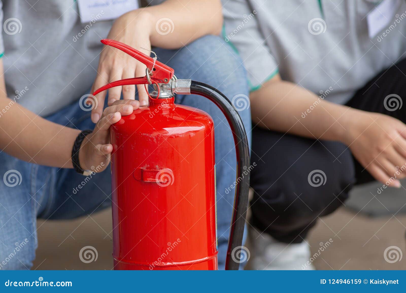 Instructor Showing How To Use a Fire Extinguisher on a Training Stock ...