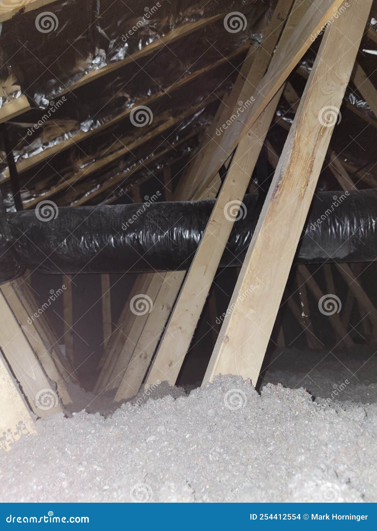 Crawl Space Under The Eves Of A House Showing Old Fibreglass Insulation ...
