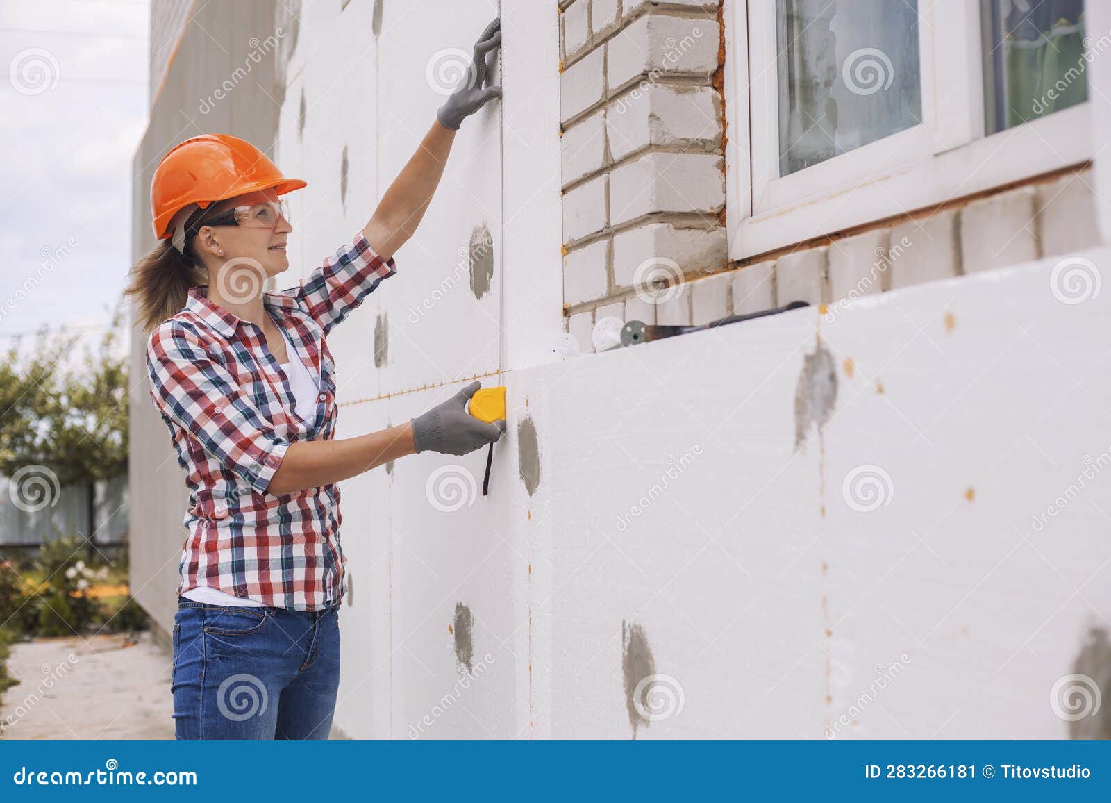 Insulation of the House with Polyfoam. the Worker is Checking with the ...