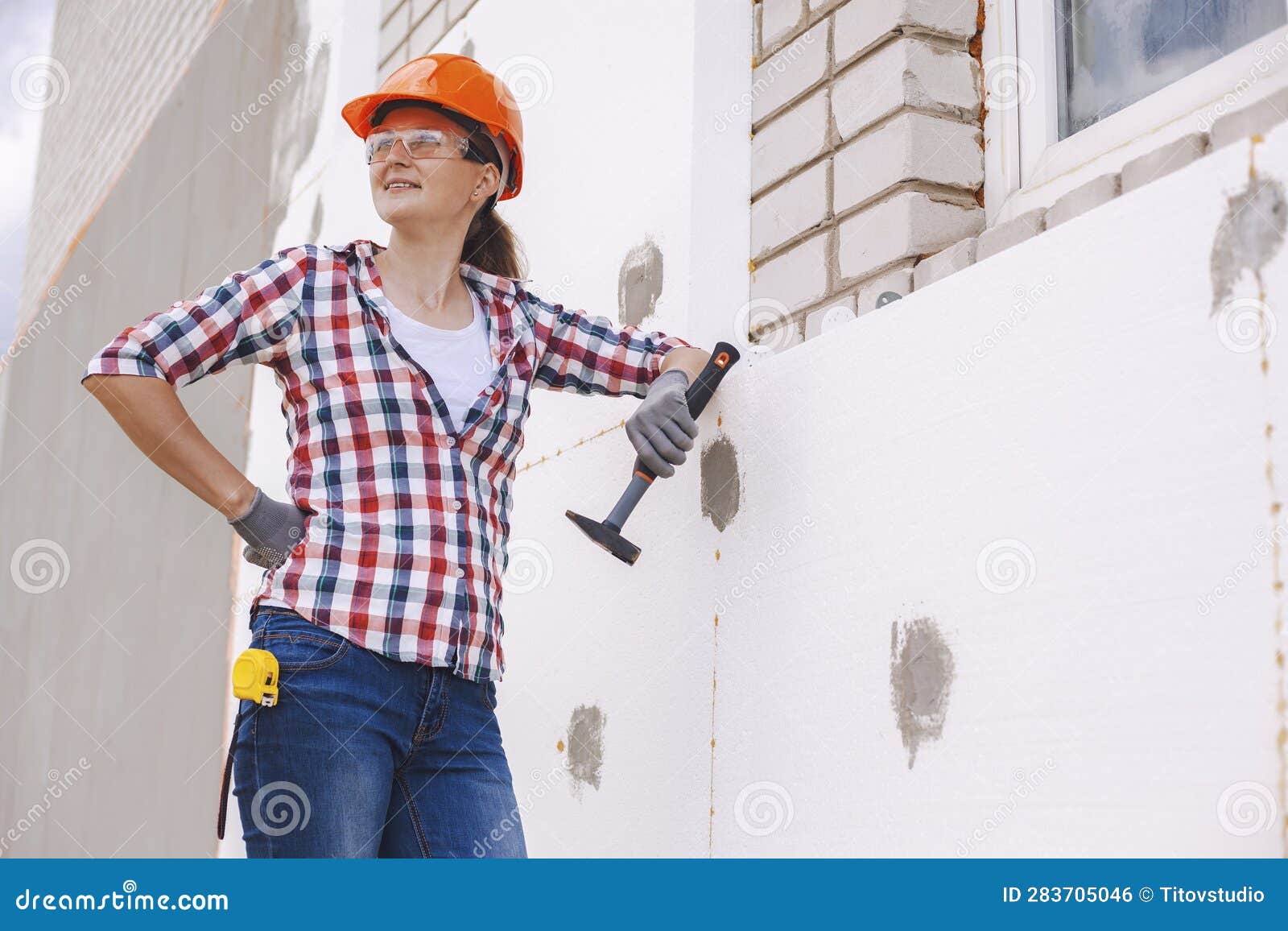 Insulation of the House with Polyfoam. the Worker is Checking with the ...