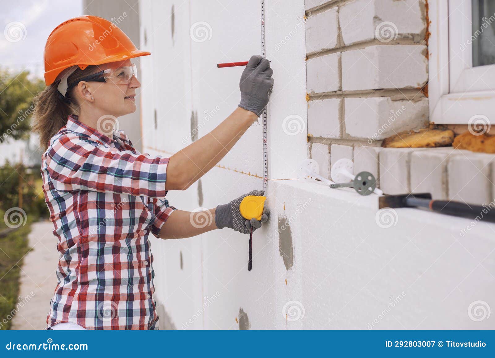Insulation of the House with Polyfoam. the Worker is Checking with the ...