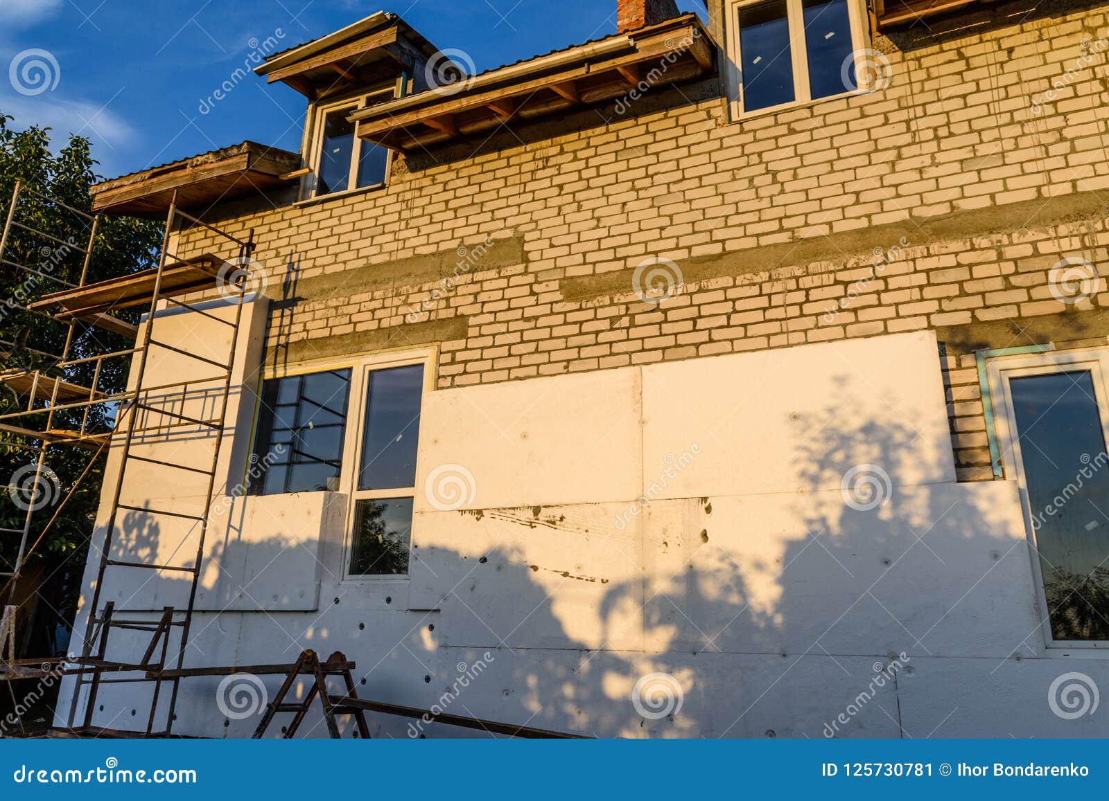 Insulation of the House with Styrofoam. Scaffold on Building Stock ...