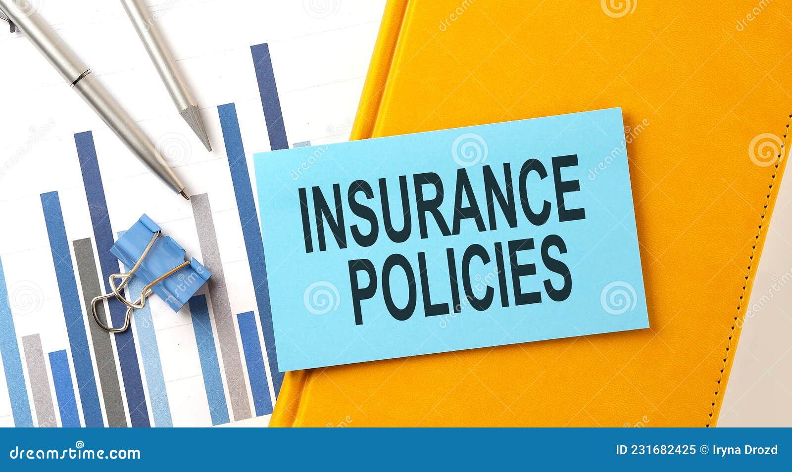 INSURANCE POLICIES Text on Sticker on Yellow Notebook with Chart and ...