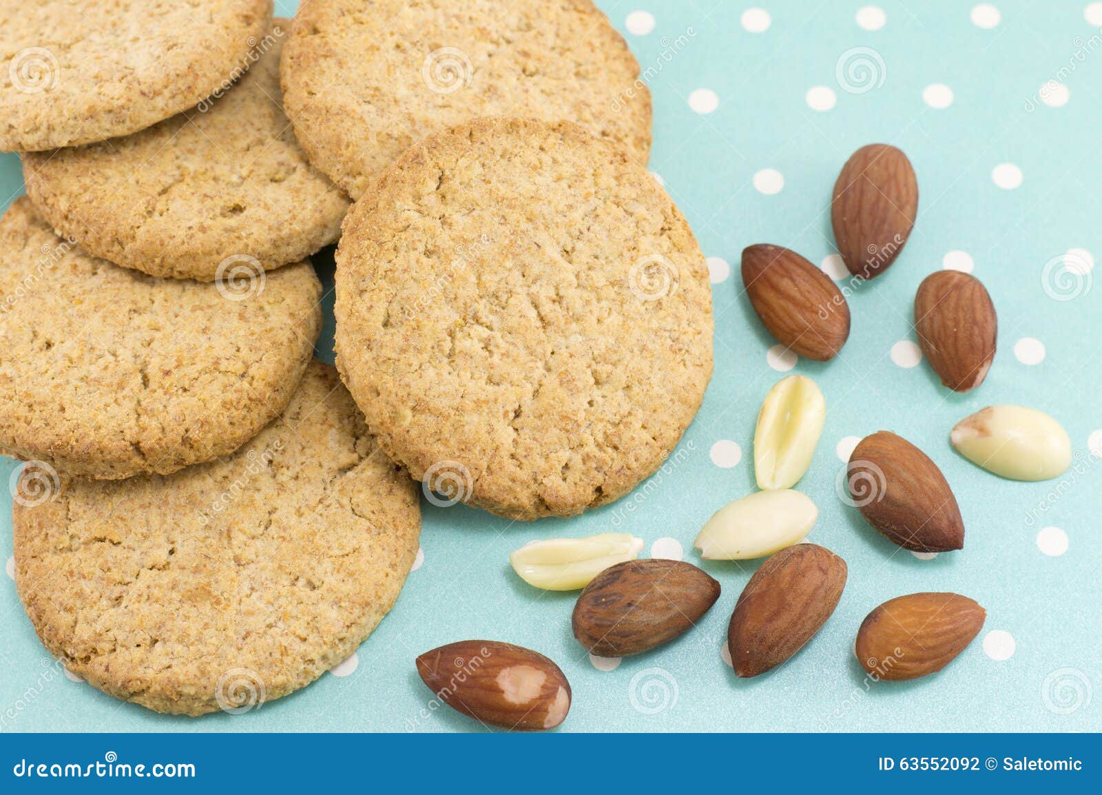 Integral Cookies with Almonds on Blue Dotted Background Stock Photo ...