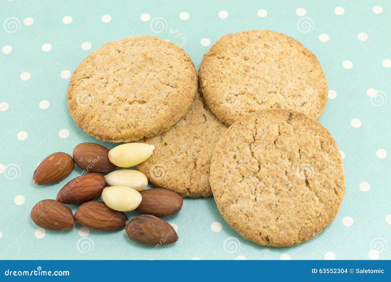 Integral Cookies with Almonds on Blue Dotted Background Stock Photo ...