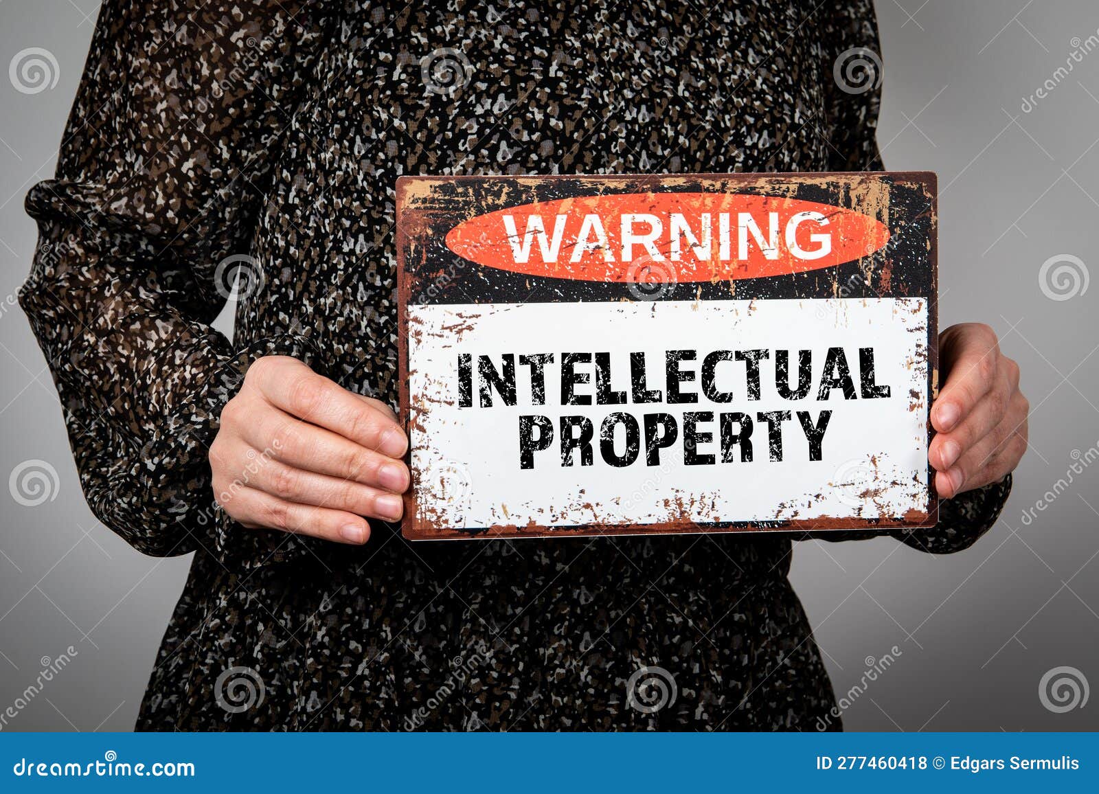 Intellectual Property. Warning Sign with Text in the Hands of a Woman ...