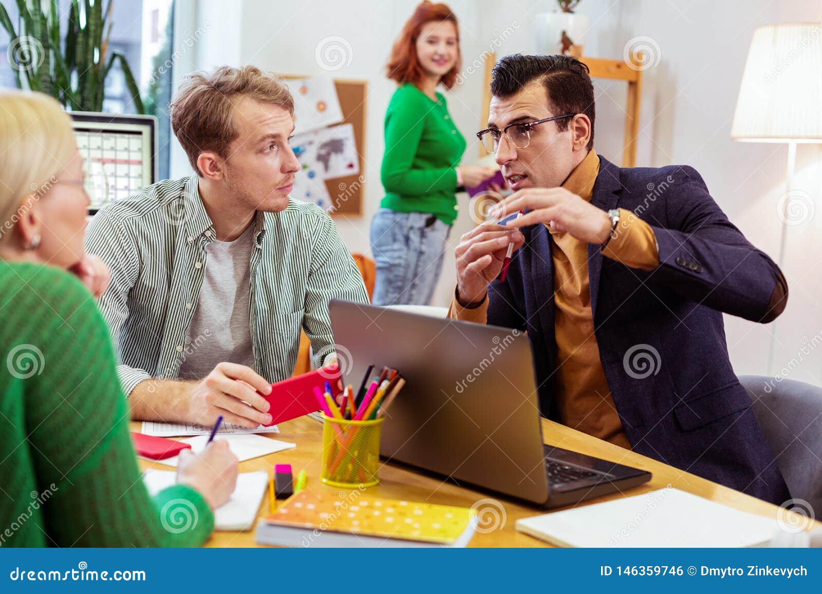 Intelligent Young Man Sharing His Knowledge with Colleagues Stock Photo ...