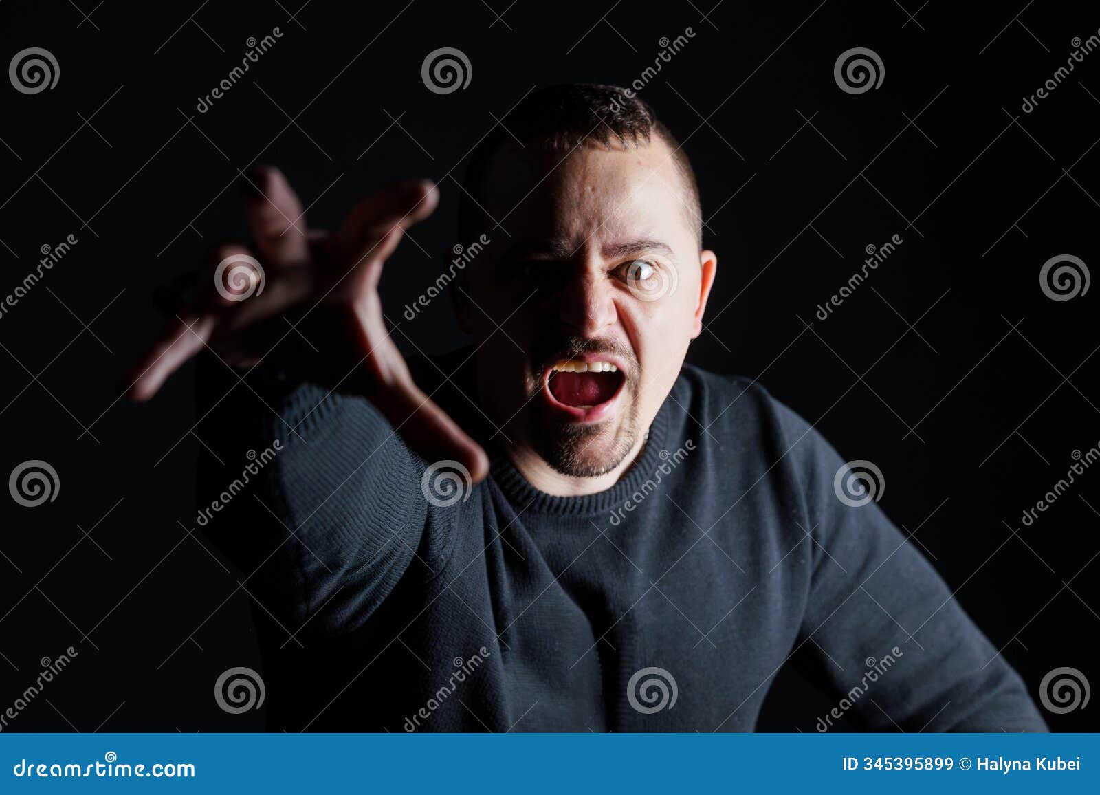 Intense Expression of Anger and Frustration in Dramatic Lighting Stock ...
