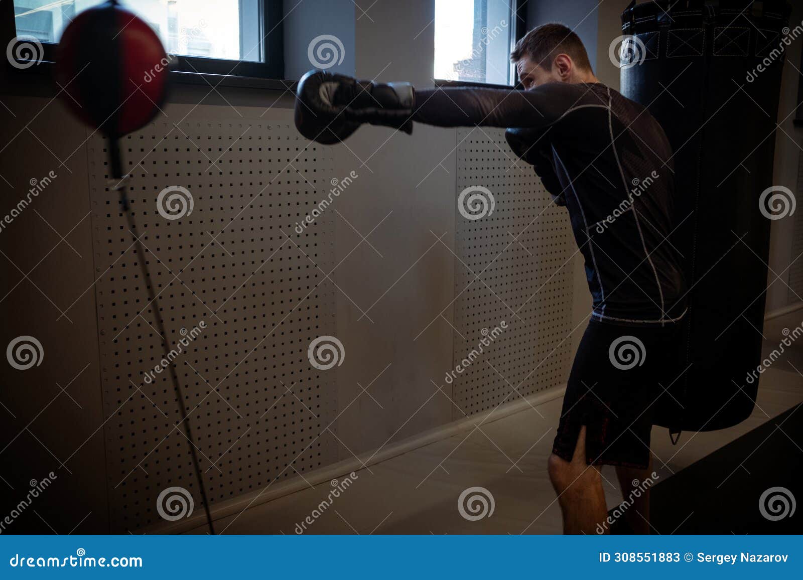 Intense Workout of Boxer Practicing on Floor-to-ceiling Bag in Gym ...