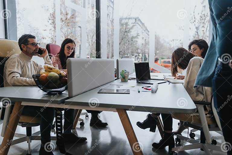 Inter Generational Group of Colleagues Collaborating on a Successful ... Inter Generational Group of Colleagues Collaborating on a Successful ...